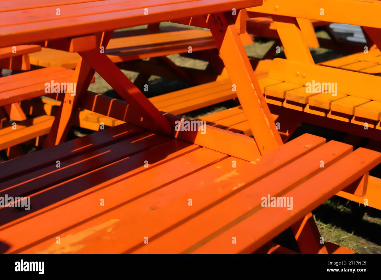 Wooden stacked benches painted orange Stock Photo - Alamy