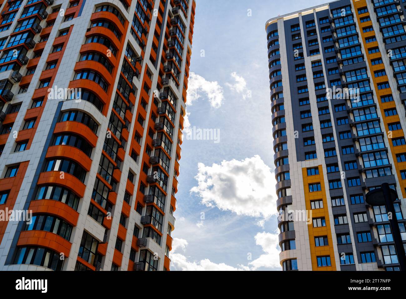 freshly built high rise apartment buildings on blue sky background with ...