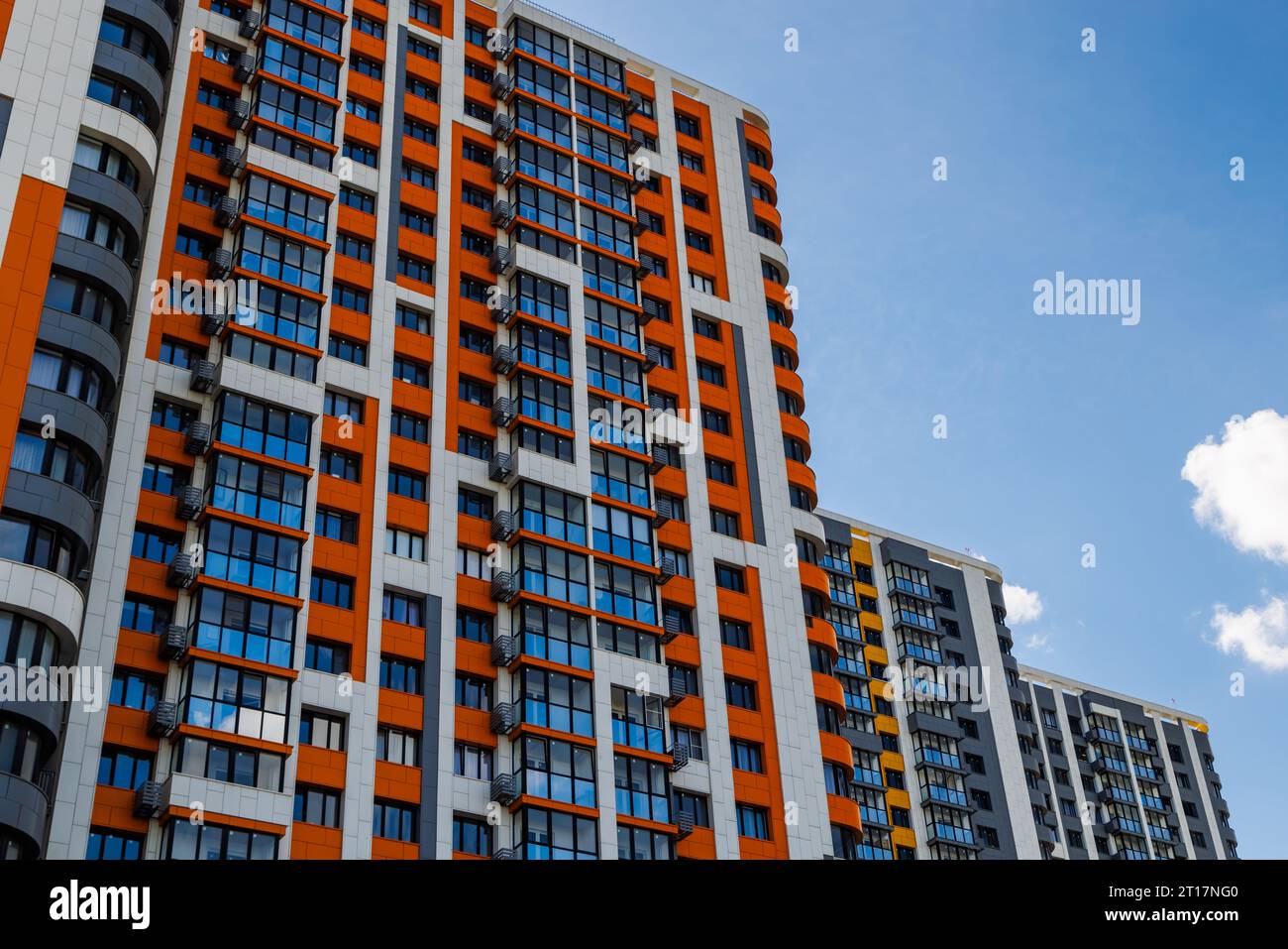 freshly built high rise apartment buildings on blue sky background with ...
