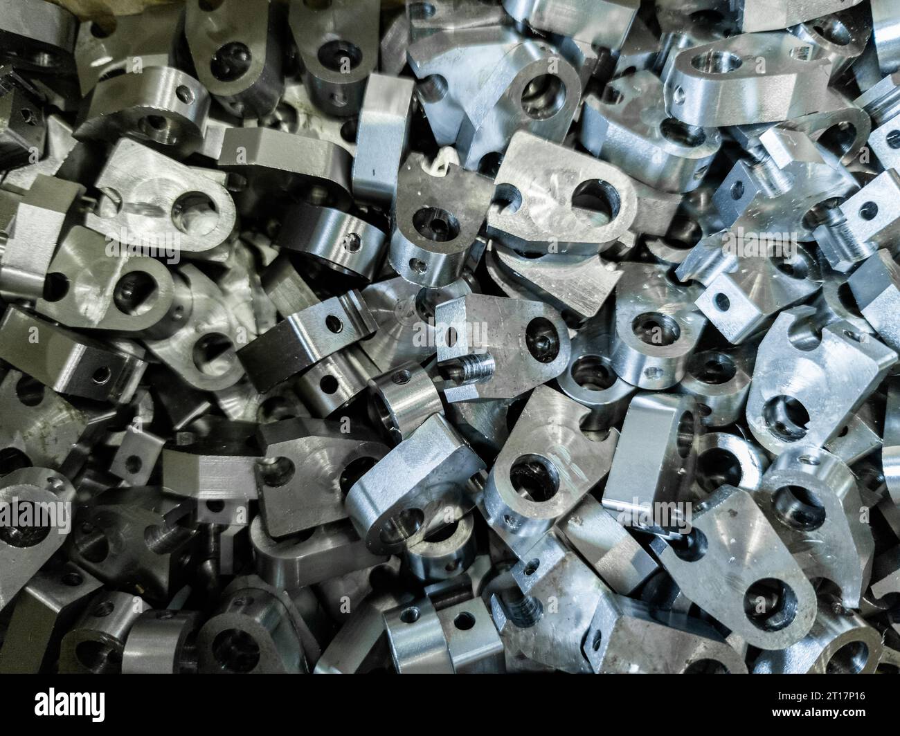 shiny steel parts background - heap of metal workpieces after milling ...