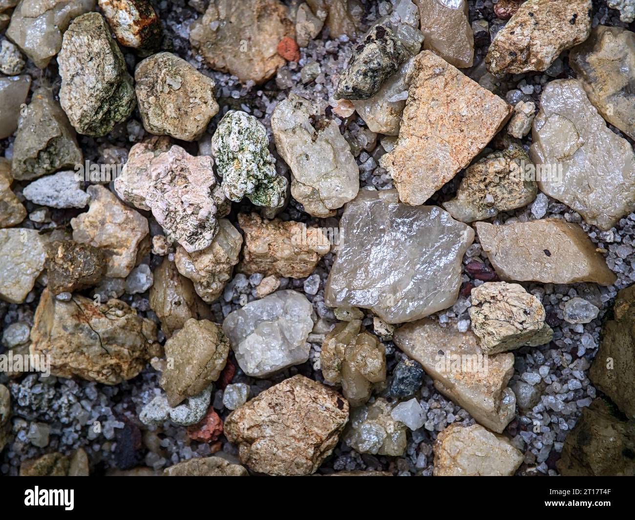 Closeup of stones that have different sizes and colors on the ground ...