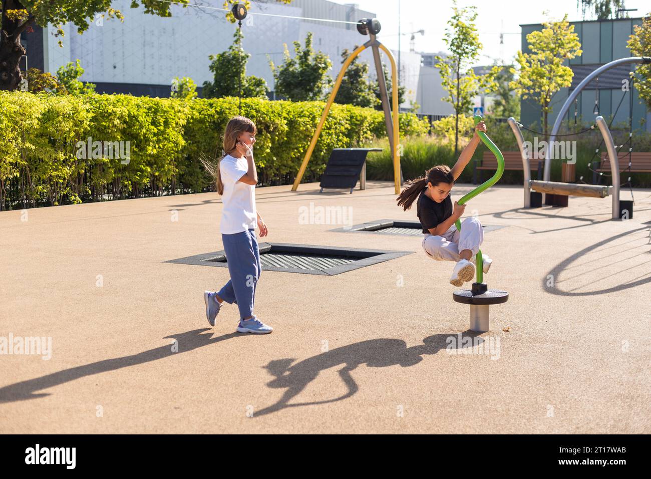 Two children spining on carousel and laughing loudly, hanging out ...