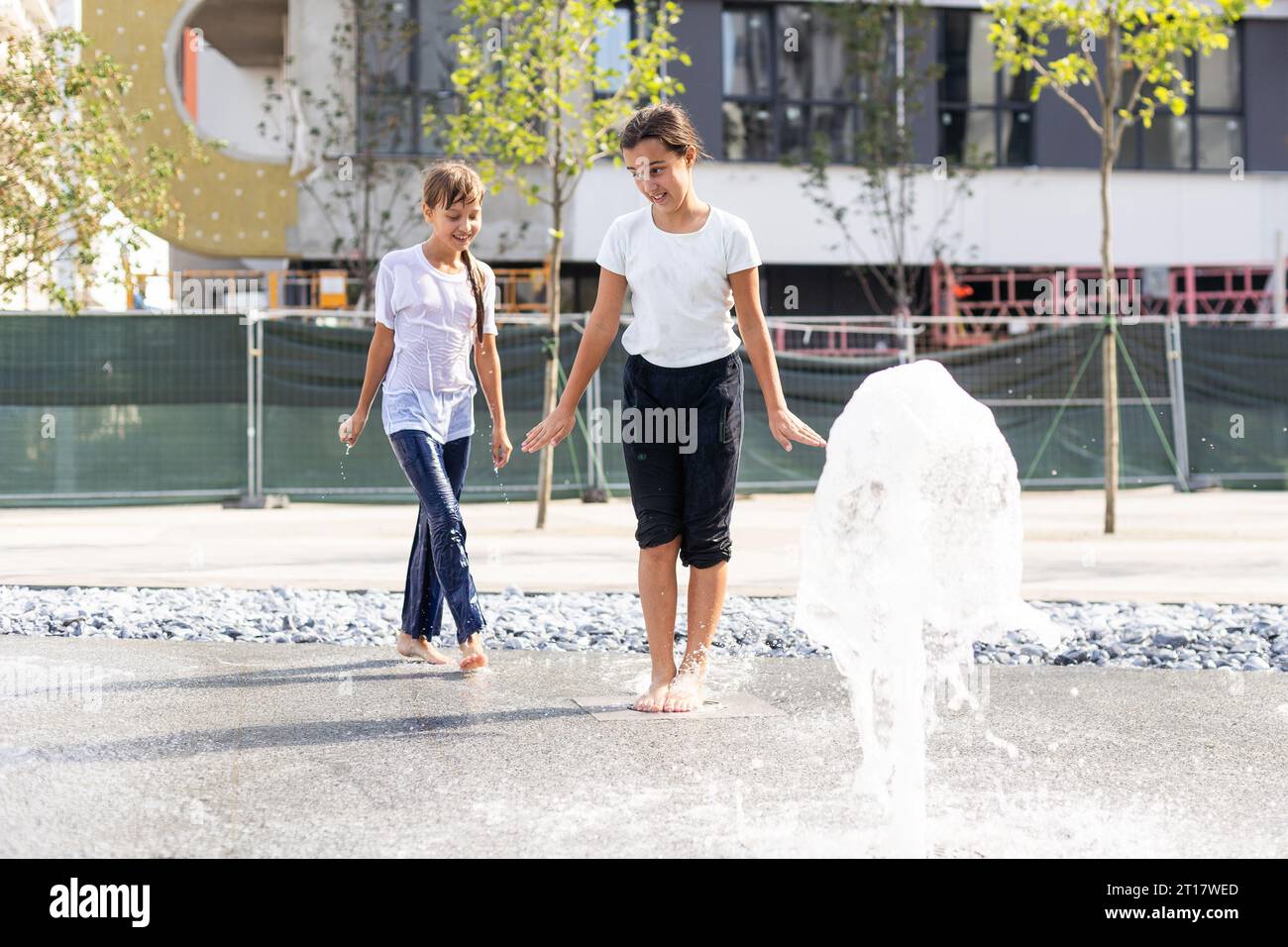 Little girls cool off in a fountain on a hot summer day Stock Photo - Alamy