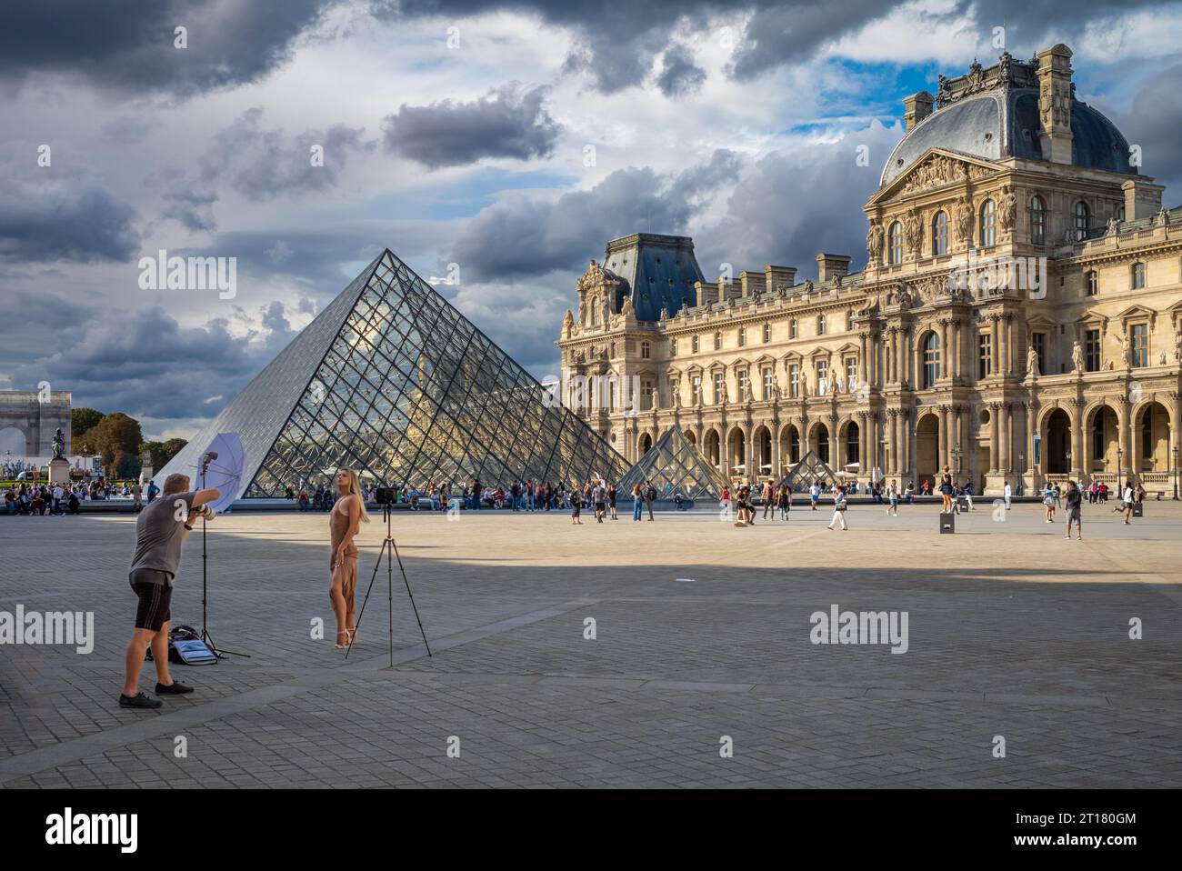 A female model and photographer in Napoleon Courtyard next to the glass ...