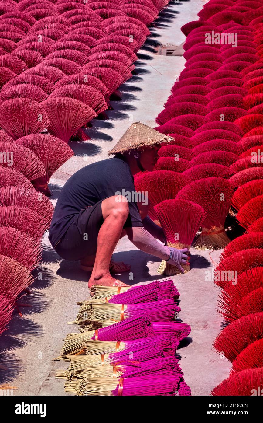 Worker drying incense in the Quang Phu Cau incense village, Hanoi ...