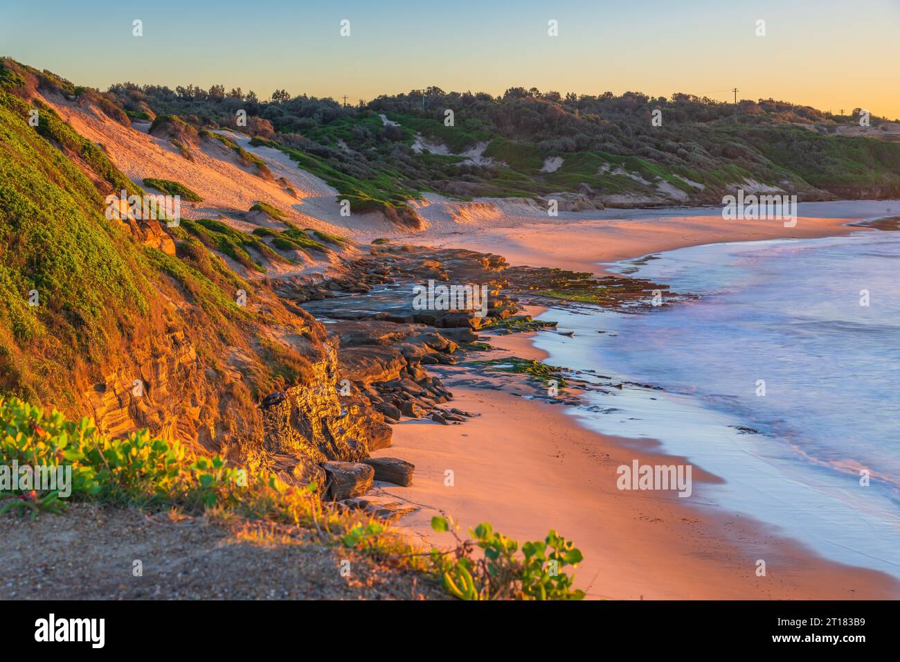 Sunrise seascape with low cloud bank at Soldiers Beach located at Norah ...