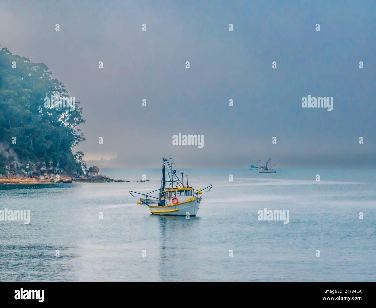 Sunrise and fog over Brisk Bay with boats at the seaside village of ...