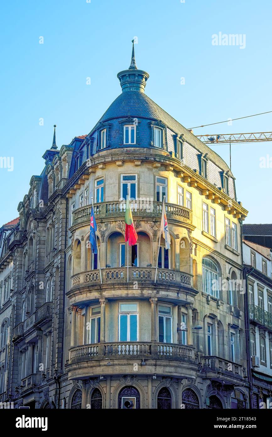 The facade of a colonial building with three flags in the old town or ...