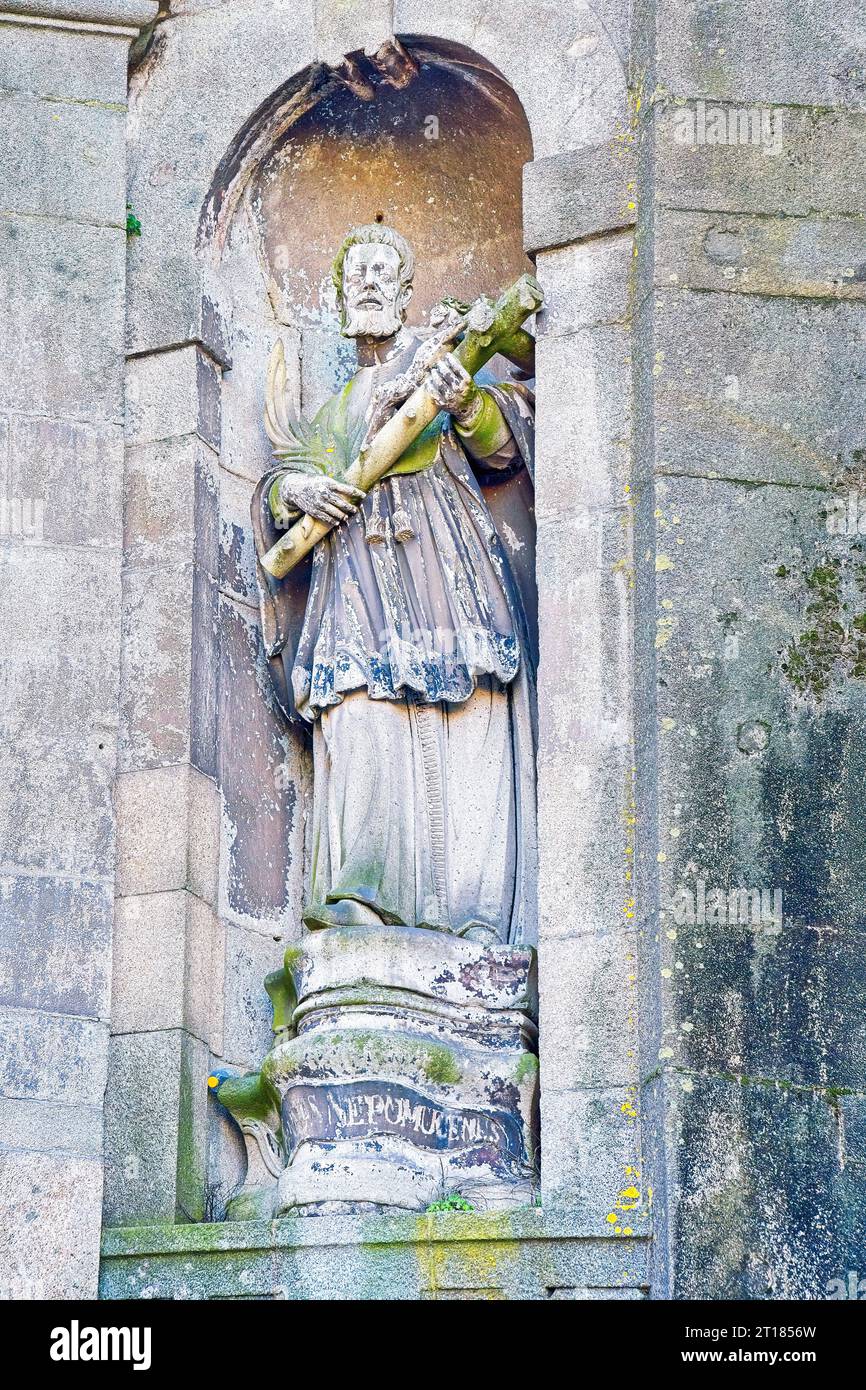Medieval sculpture or statue of a religious saint decorating the facade ...