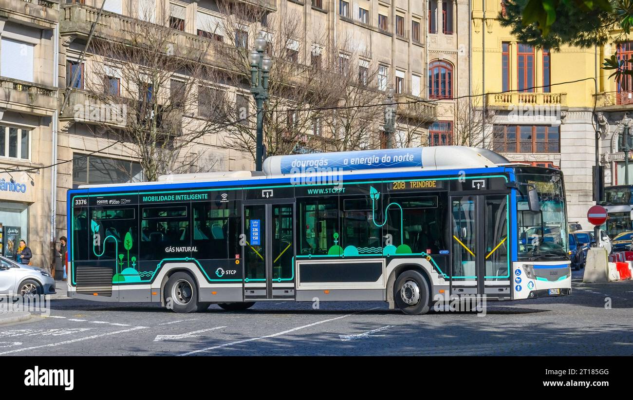 A public transportation bus moves on a city street. The motor vehicle ...