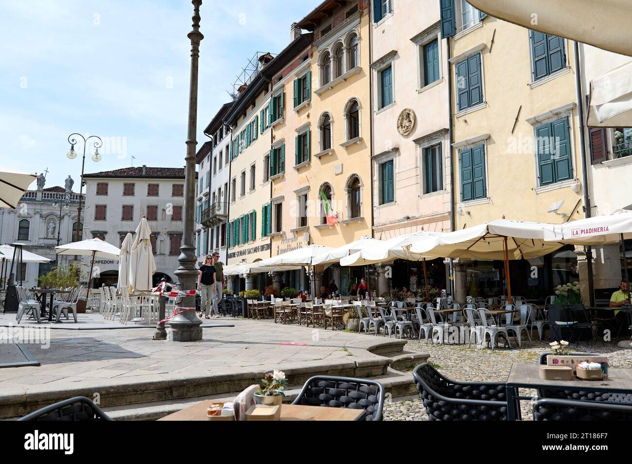 Colonnade and path, square of the freedom in Italian city Udine. People ...