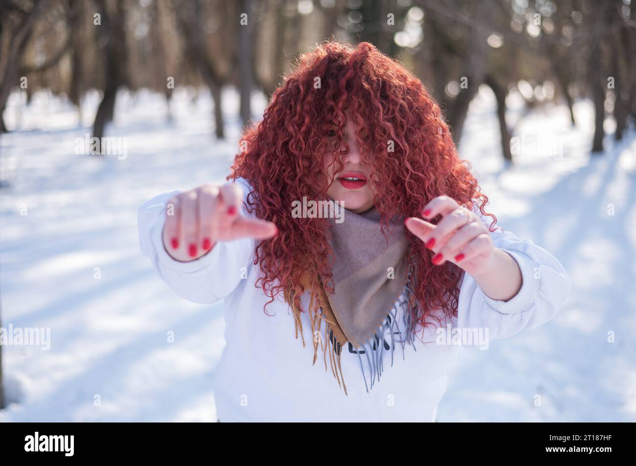 The plump-cheeked woman threw her red hair over her face and held out ...