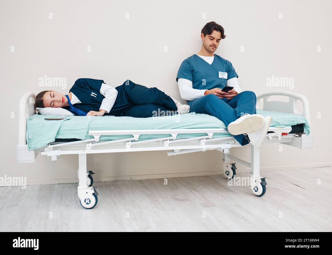 Tired doctors, sleeping woman and man with phone, texting and relax on ...