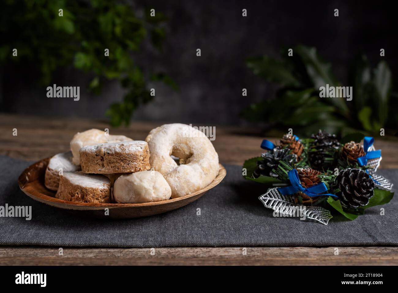 Shortbread, wine donuts and puff pastries next to a Christmas ornament ...