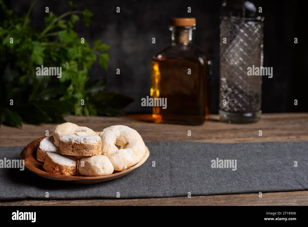 Shortbread, wine donuts and puff pastry on a wooden plate, and in the ...
