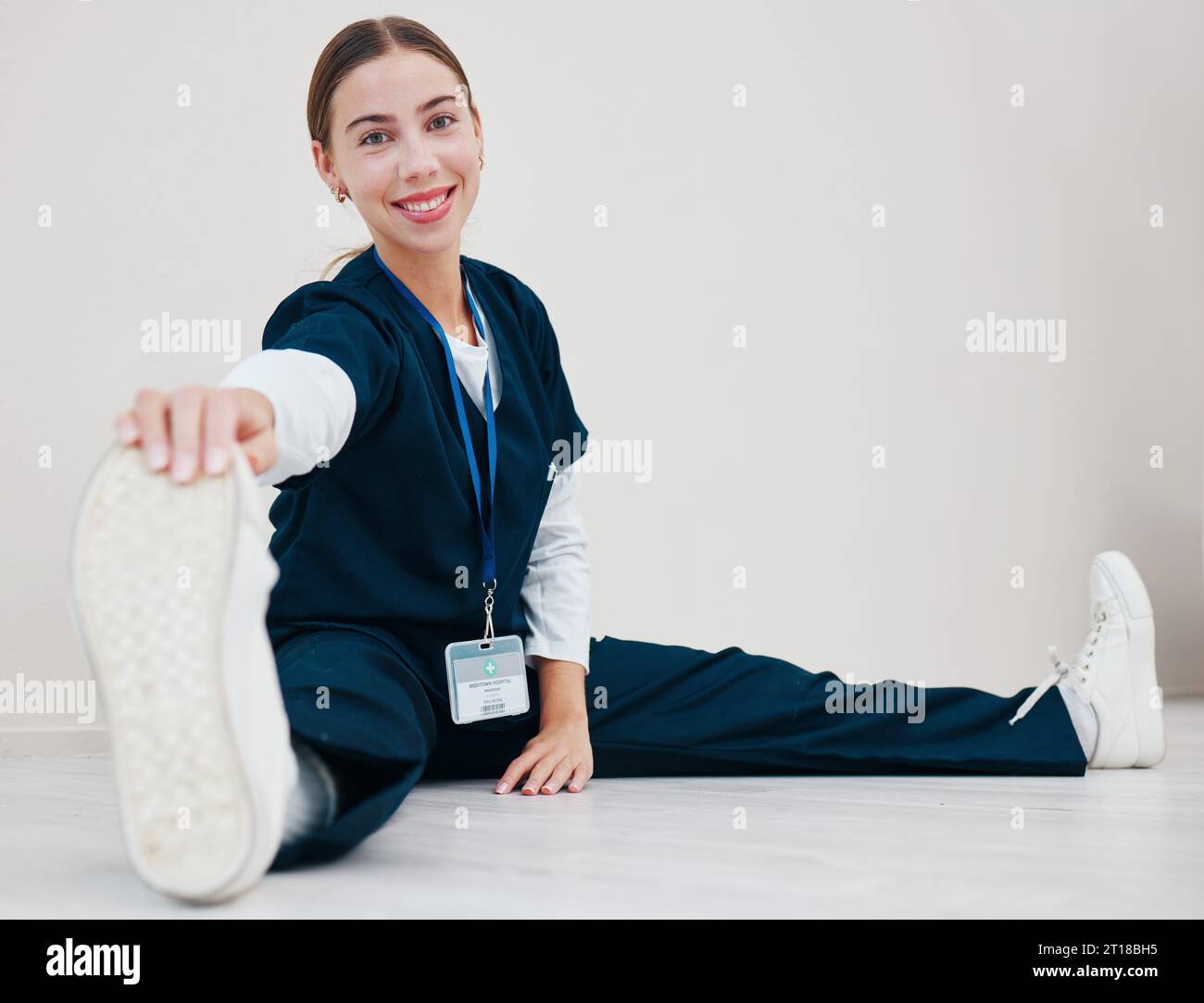 Stretching, feet and nurse with legs on floor in exercise at the start ...