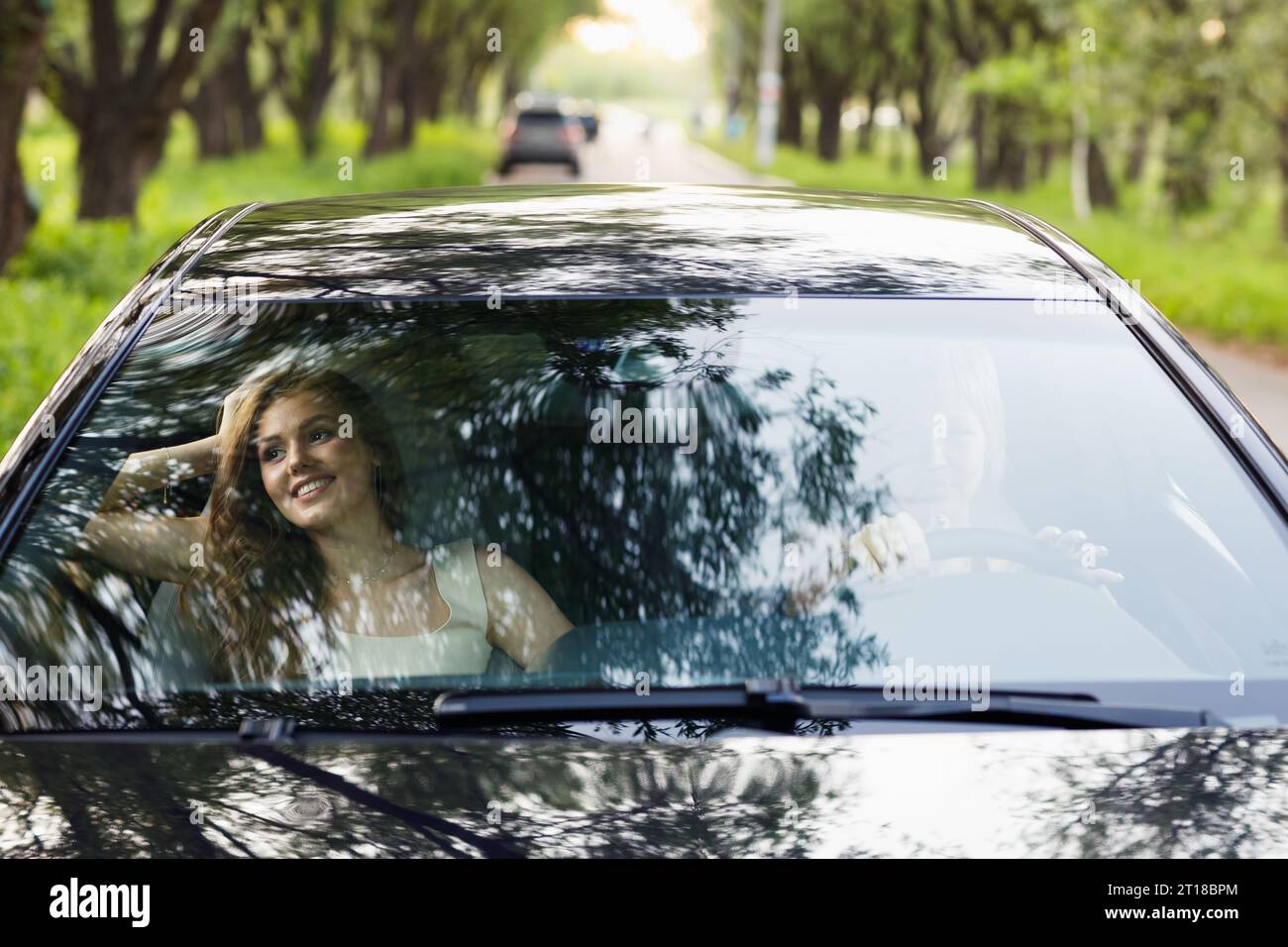 Two woman drivers at car smiling. Cute young happy female driving car ...