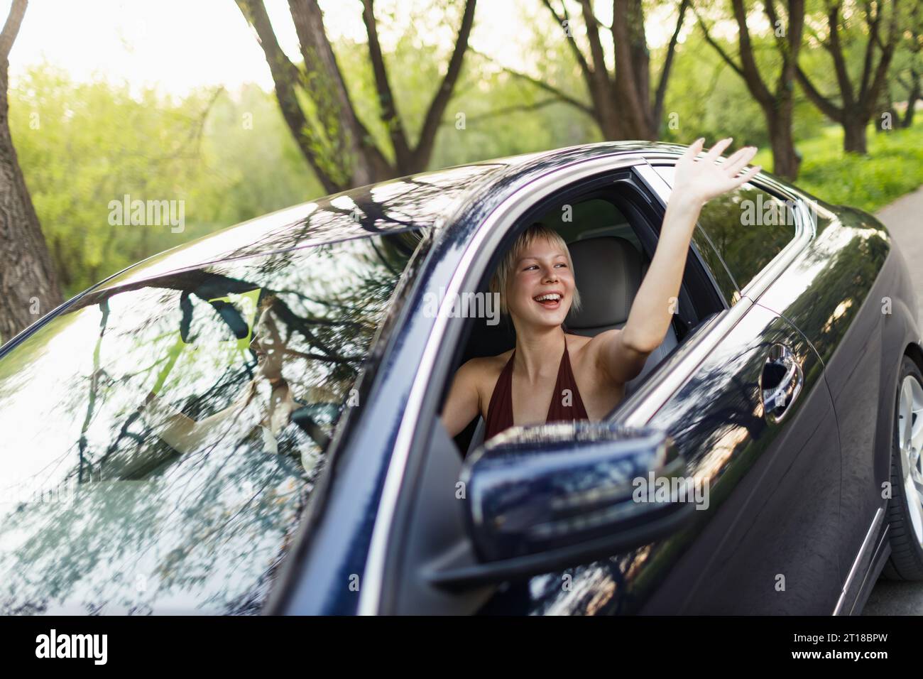 Two woman drivers at car smiling dancing hans up. Cute young happy ...