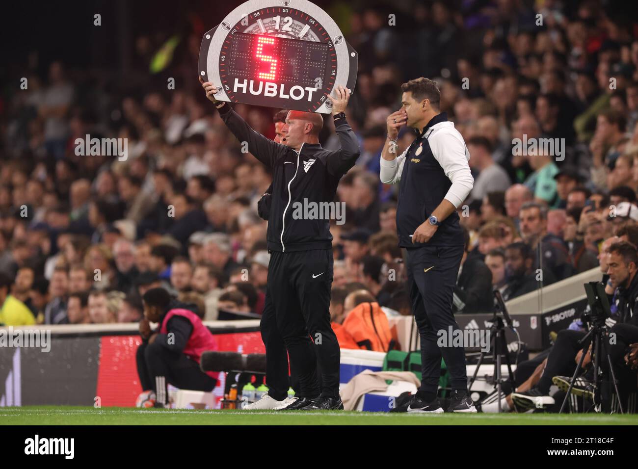 Fourth official Simon Hooper holds up the board to say 5 minutes of ...