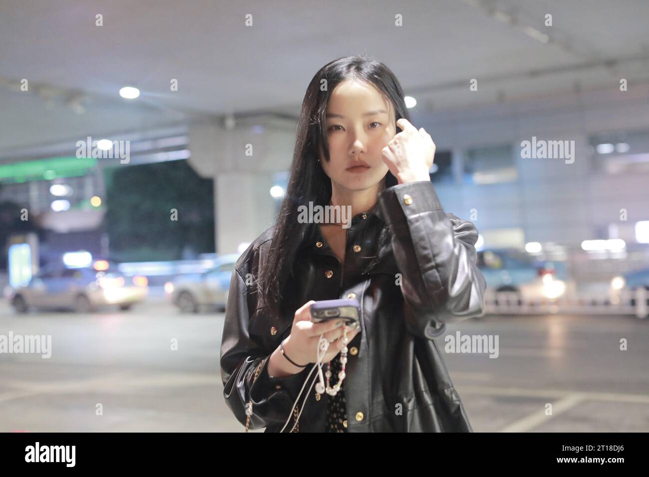 Chinese singer Huang Ling appears at the airport in Changsha City, south China's Hunan Province ...