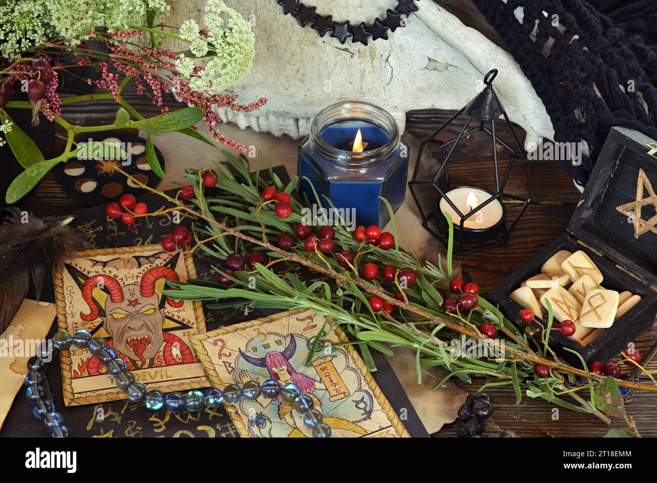 Tarot cards and runes with candles on altar witch table. Occult ...