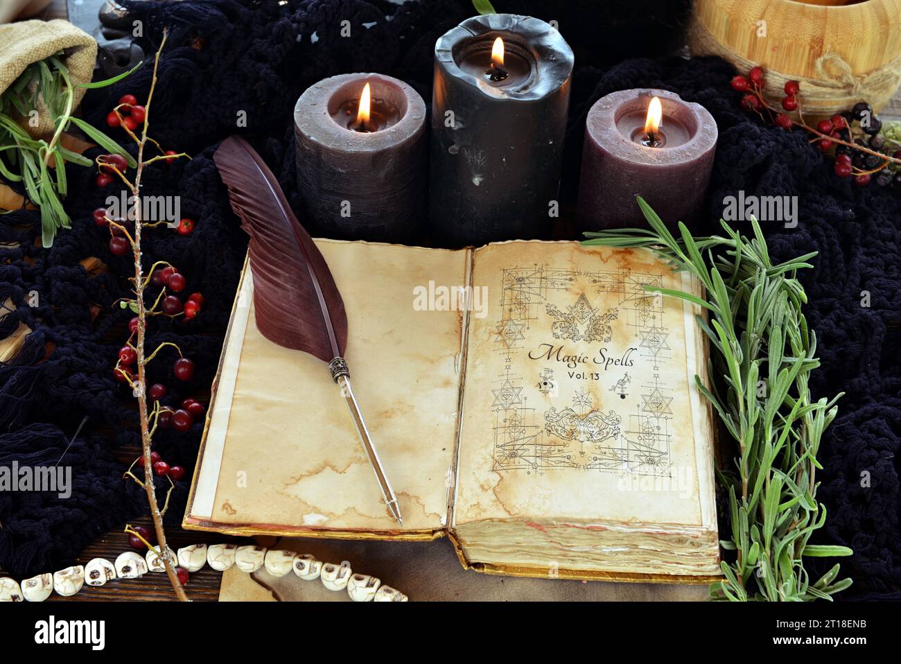 Witch book of spells with black candles on altar table. Occult ...