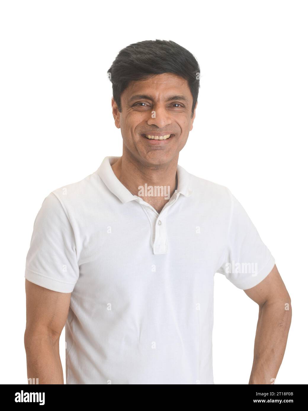 A smart middle-aged fit Indian man in a white t-shirt - studio shot ...