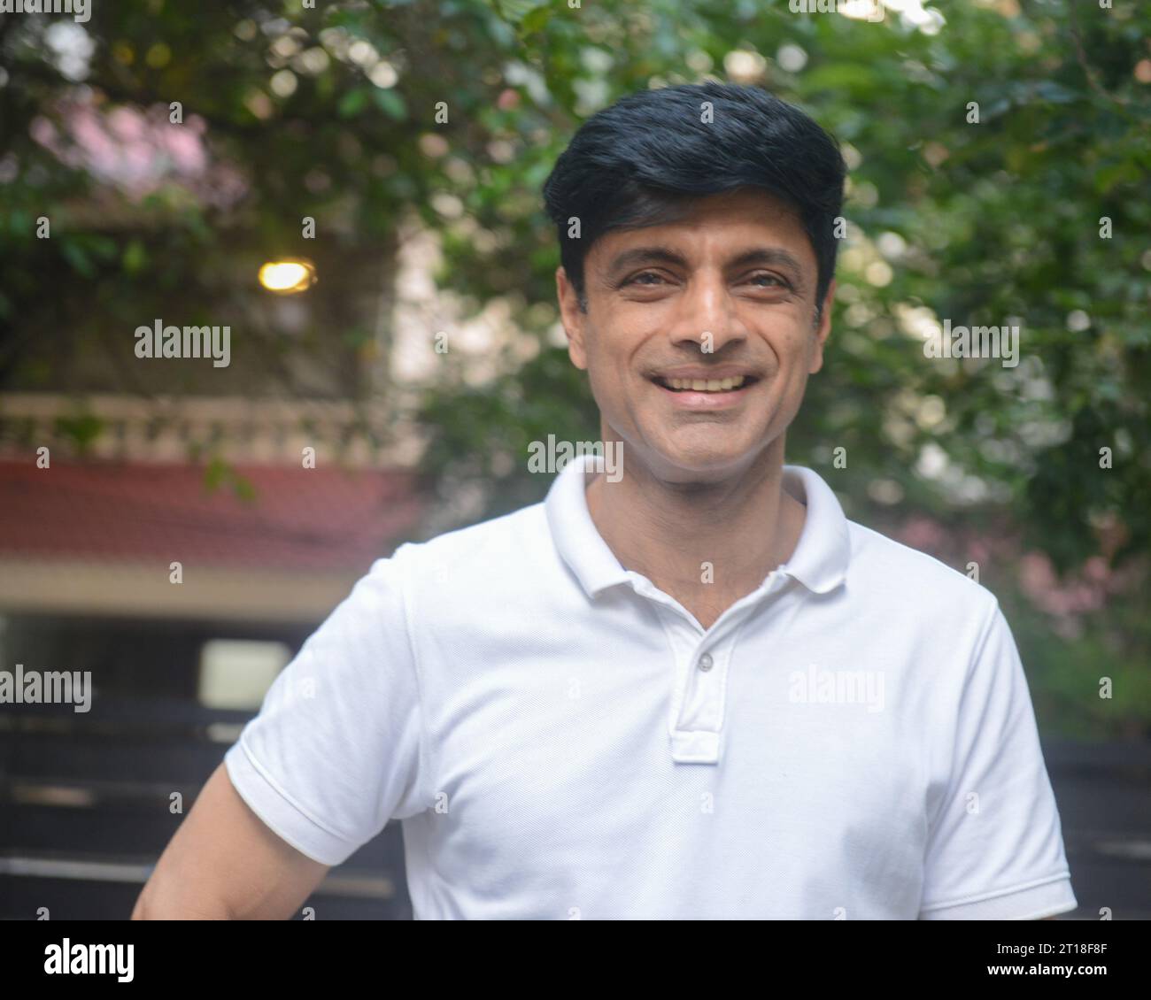 A smart middle-aged fit Indian man in a white t-shirt - outdoors Stock ...