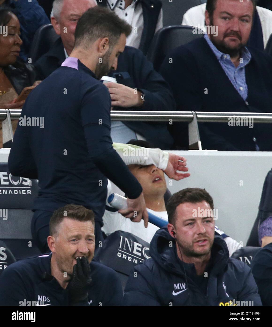 Son Heung-Min of Tottenham Hotspur looks in pain as a physio straps ice ...