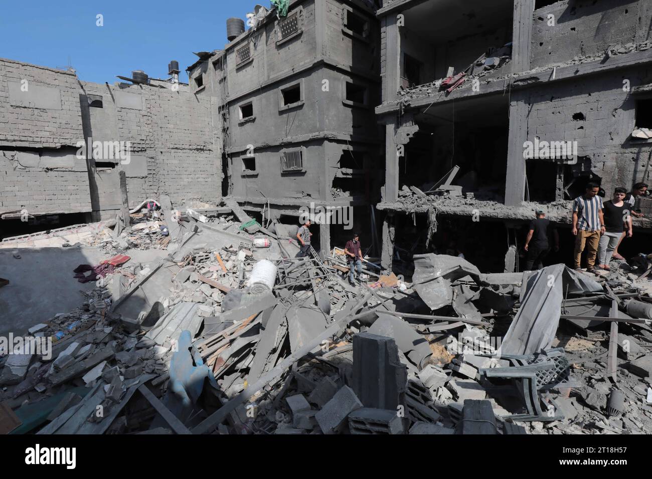 Gaza City. October 12, 2023. People are seen around destroyed buildings ...
