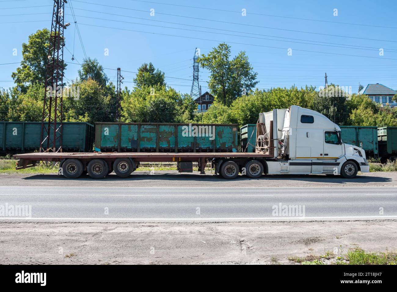 White long distance bonnet truck with a semitrailer at a freight ...