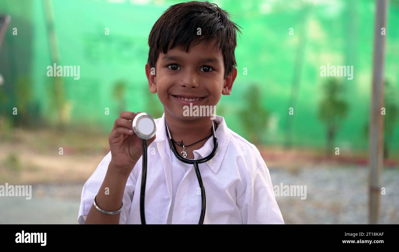 Cute small Indian kid boy wear medical uniform holding stethoscope ...