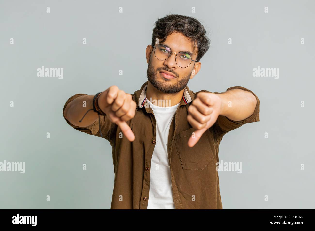 Dislike. Upset unhappy Indian man showing thumbs down sign gesture ...