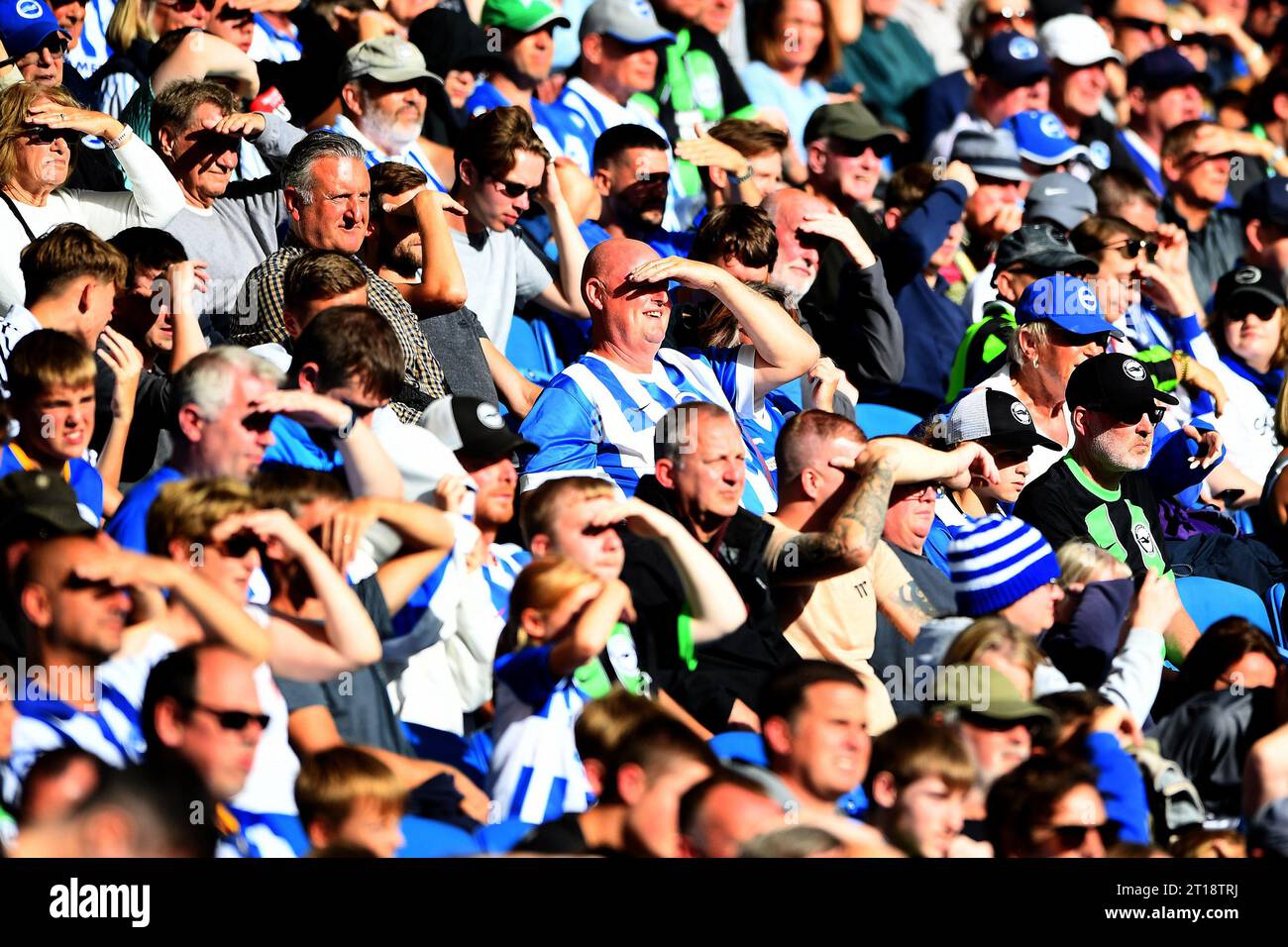 Fans shield their eyes from the sun hi-res stock photography and images ...