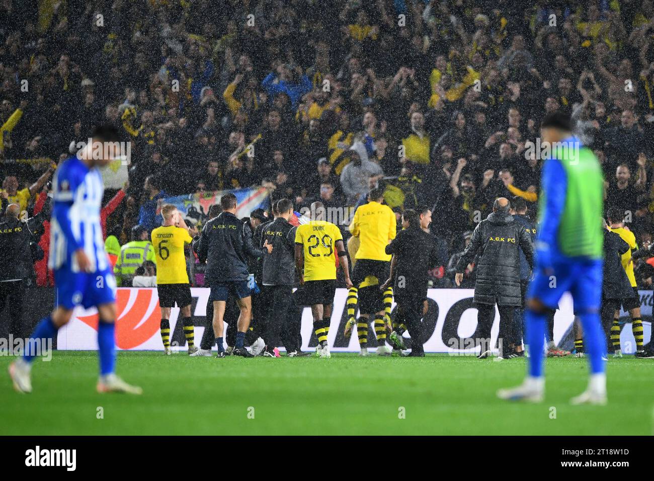 AEK Athens players celebrate as Brighton and Hove Albion players look ...
