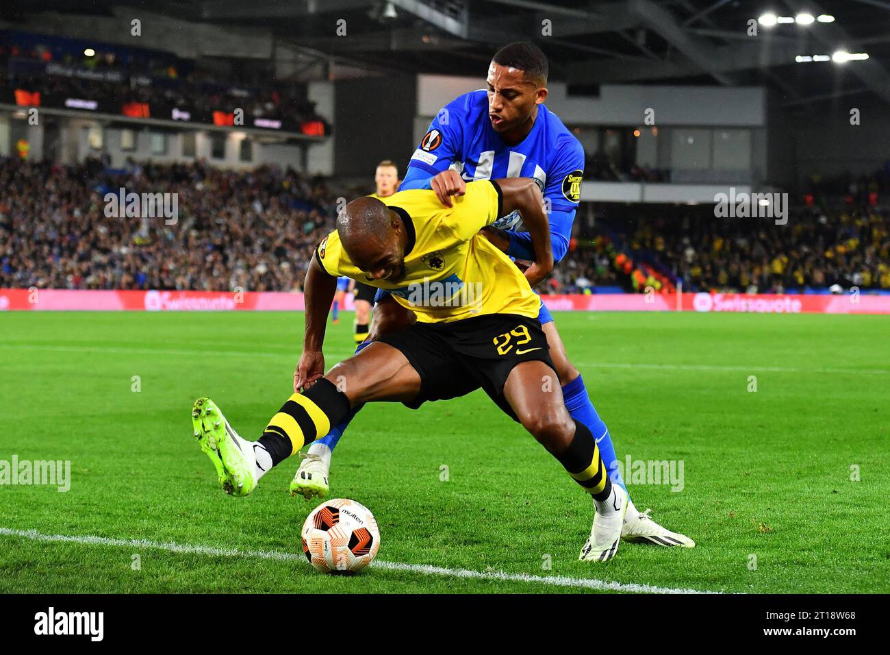 Djibril Sidibe of AEK Athens and Joao Pedro of Brighton and Hove Albion ...