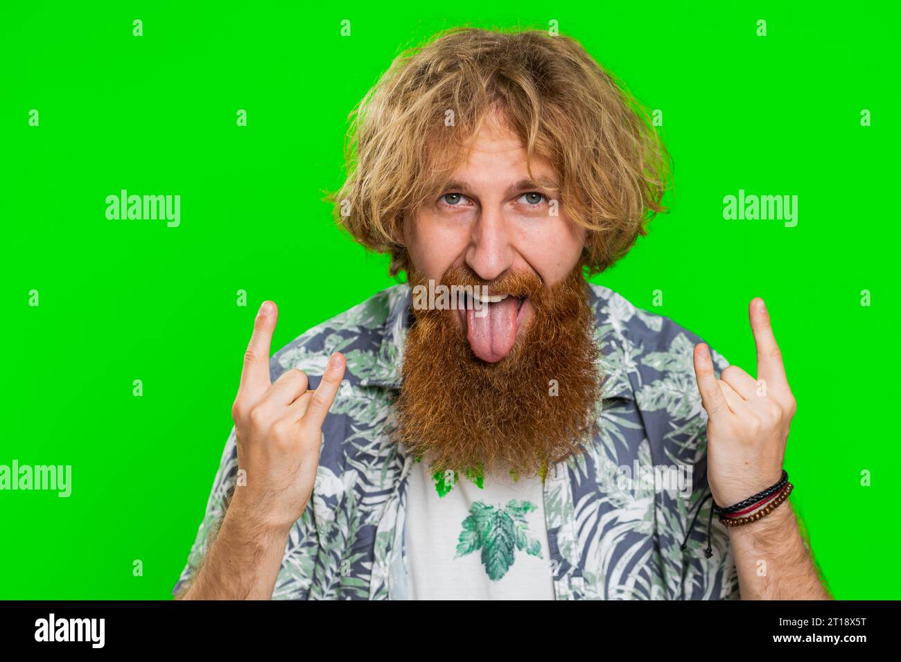 Overjoyed happy young caucasian man showing rock n roll gesture by ...