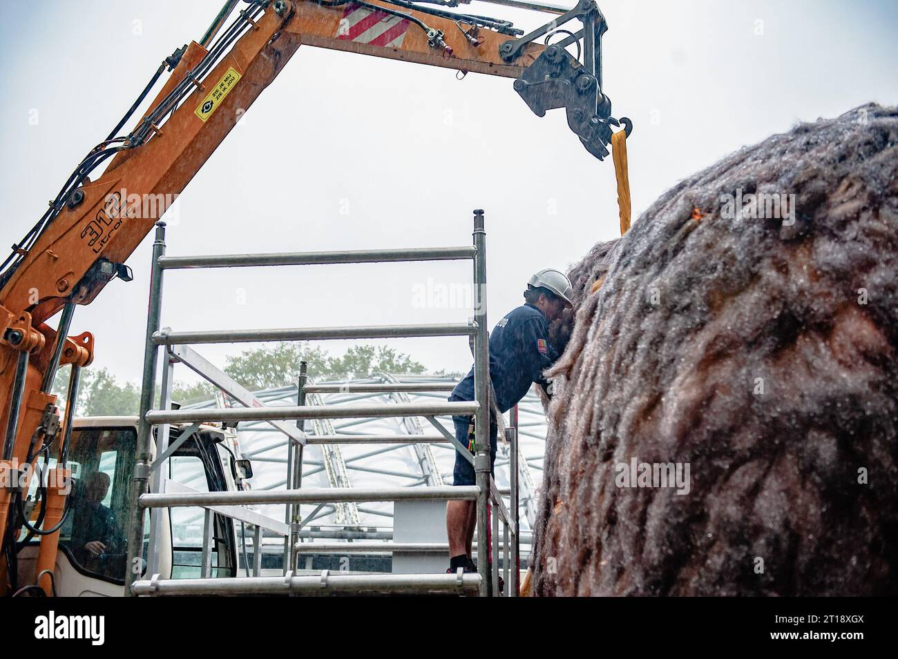 A technician is seen completing the assembling of the head. This ...