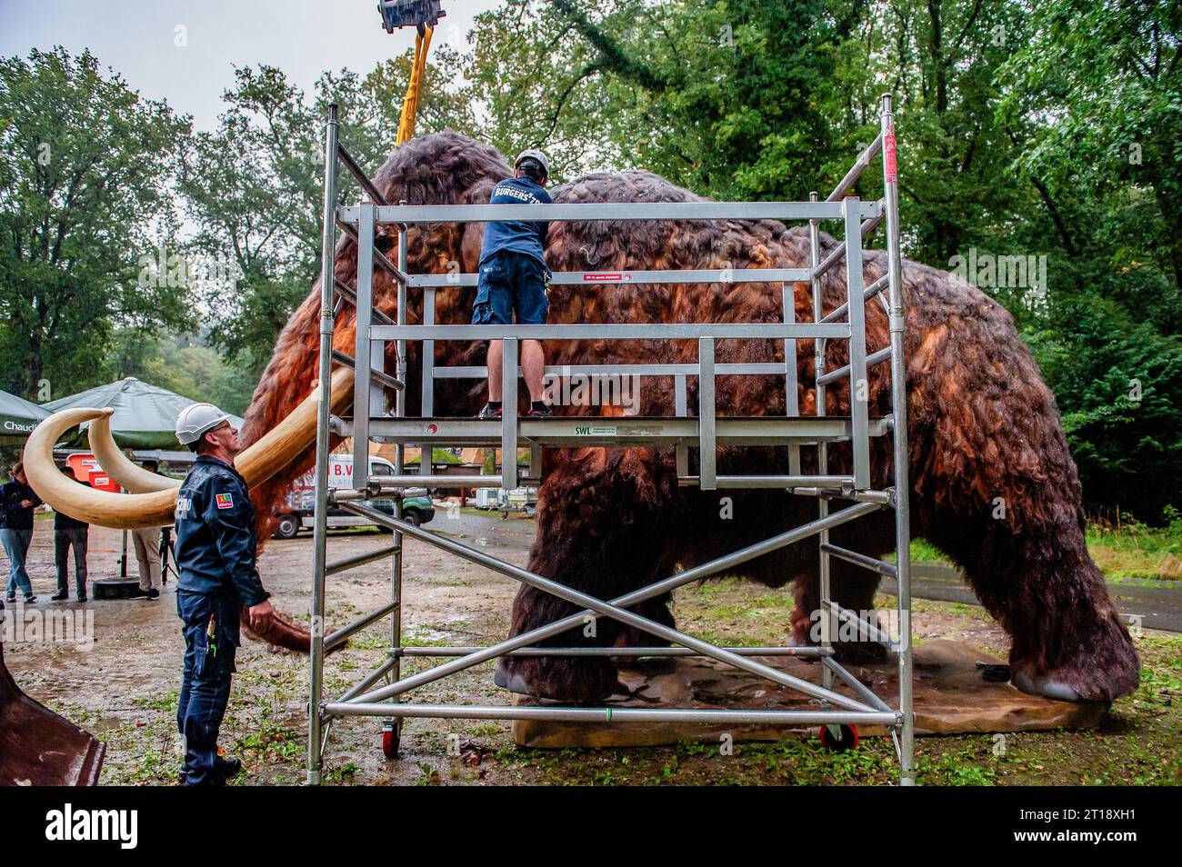 Two technicians are seen completing the assembling of the head. This ...