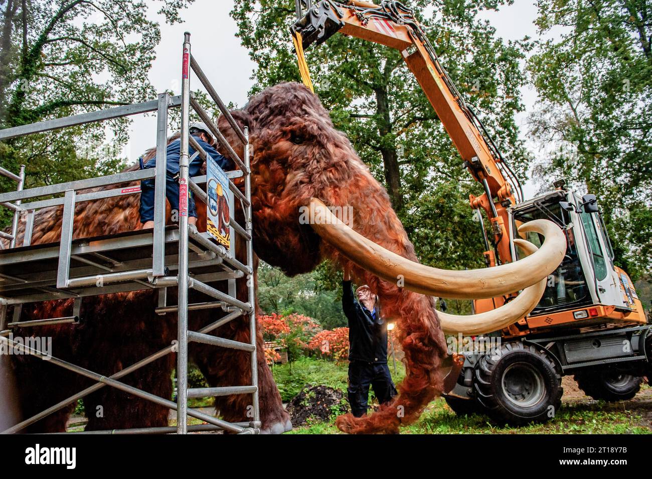 Two technicians are seen placing the head in the right place. This ...