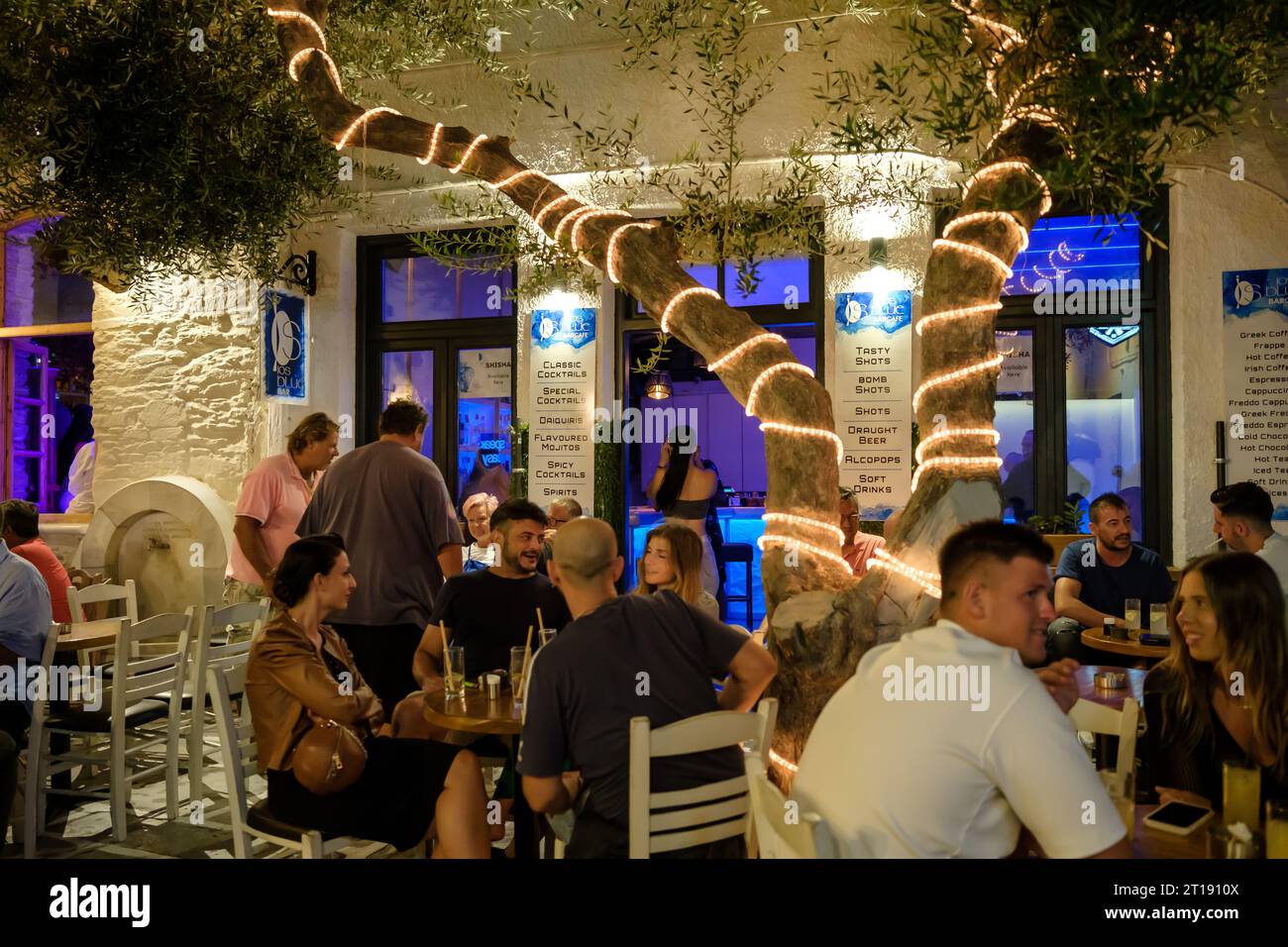 Ios, Greece - September 8, 2023 : Tourists surrounded by bars, enjoying ...