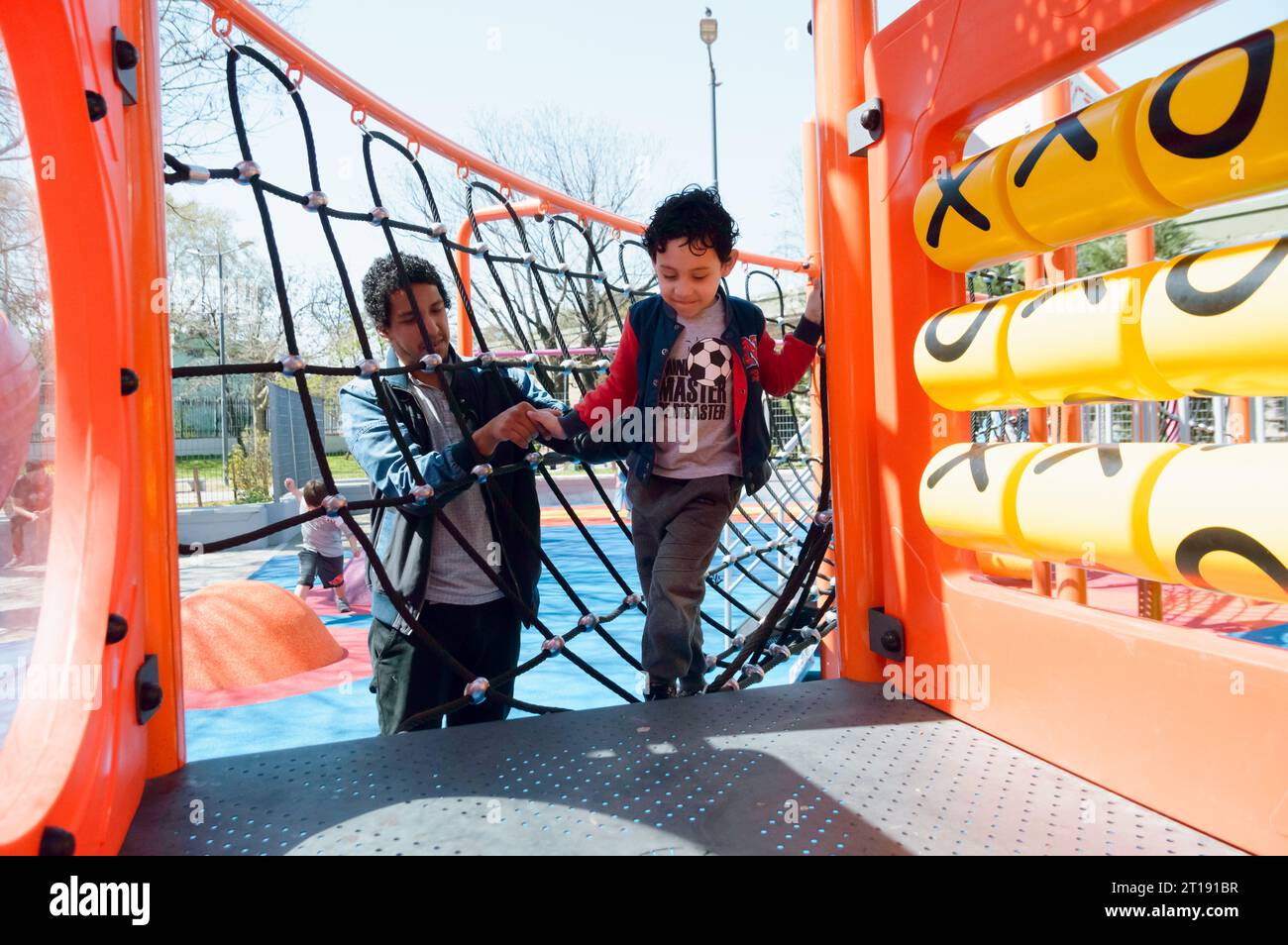 Afro Latino man father taking care of his son who is happy, playing and ...