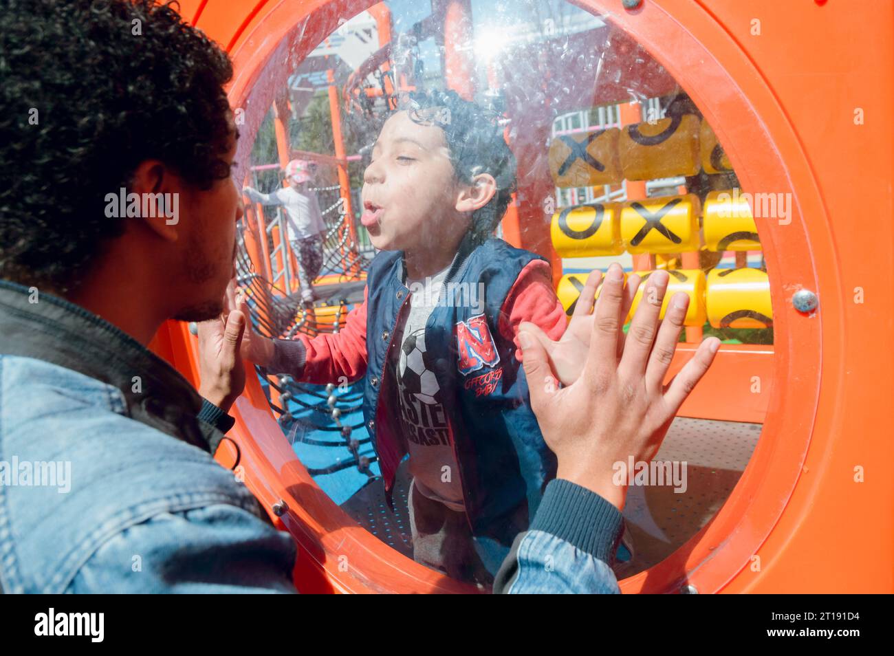 young Latino father and son, happy playing among plastic games in ...