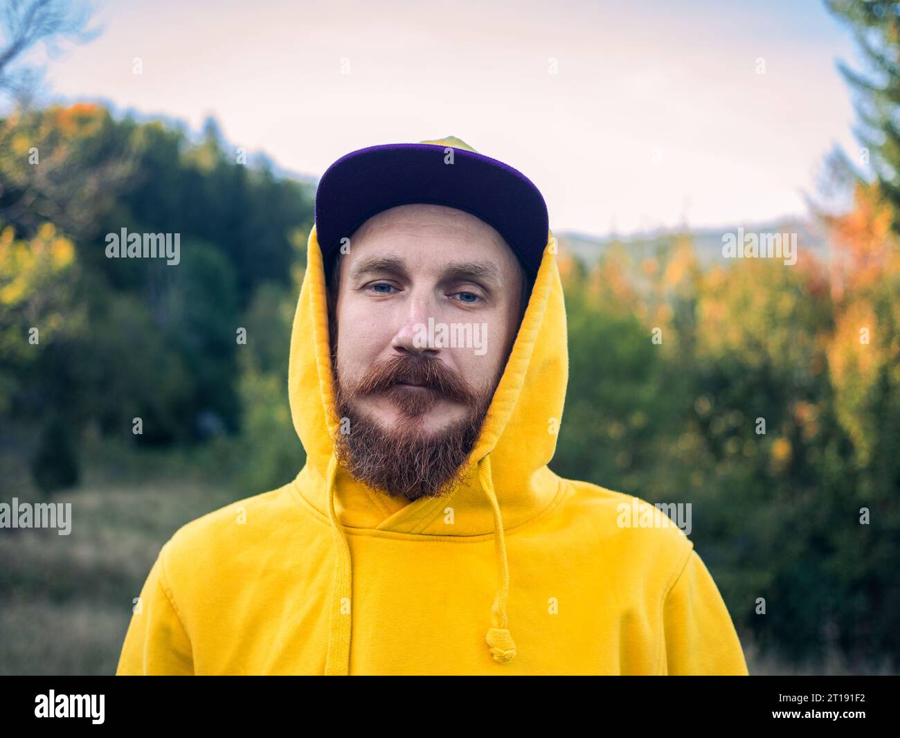 Red bearded millennial man with mustache in yellow hoody smiling ...