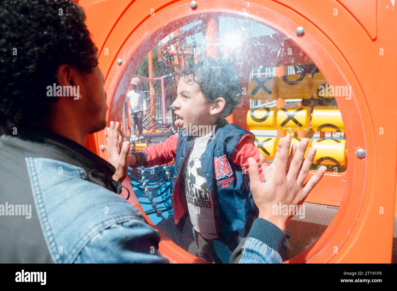 Young Latino Father And Son Happy Playing Among Plastic Games In