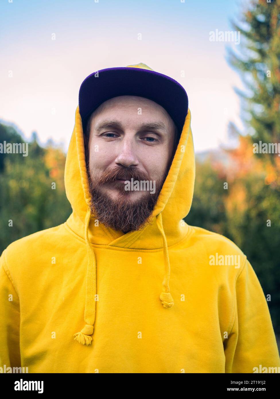 Red bearded millennial man with mustache in yellow hoody smiling ...