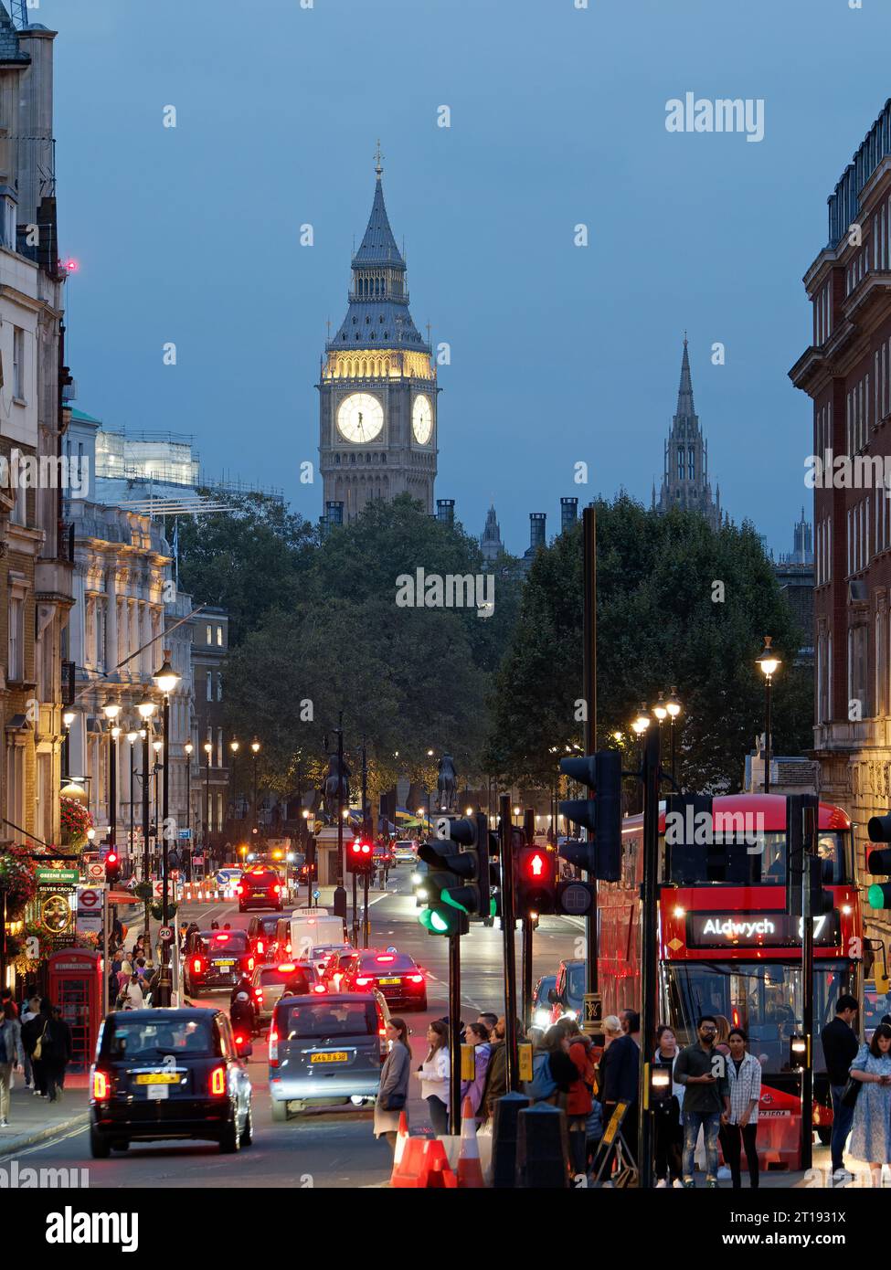 View looking down a busy Whitehall in London at night with Big Ben in ...