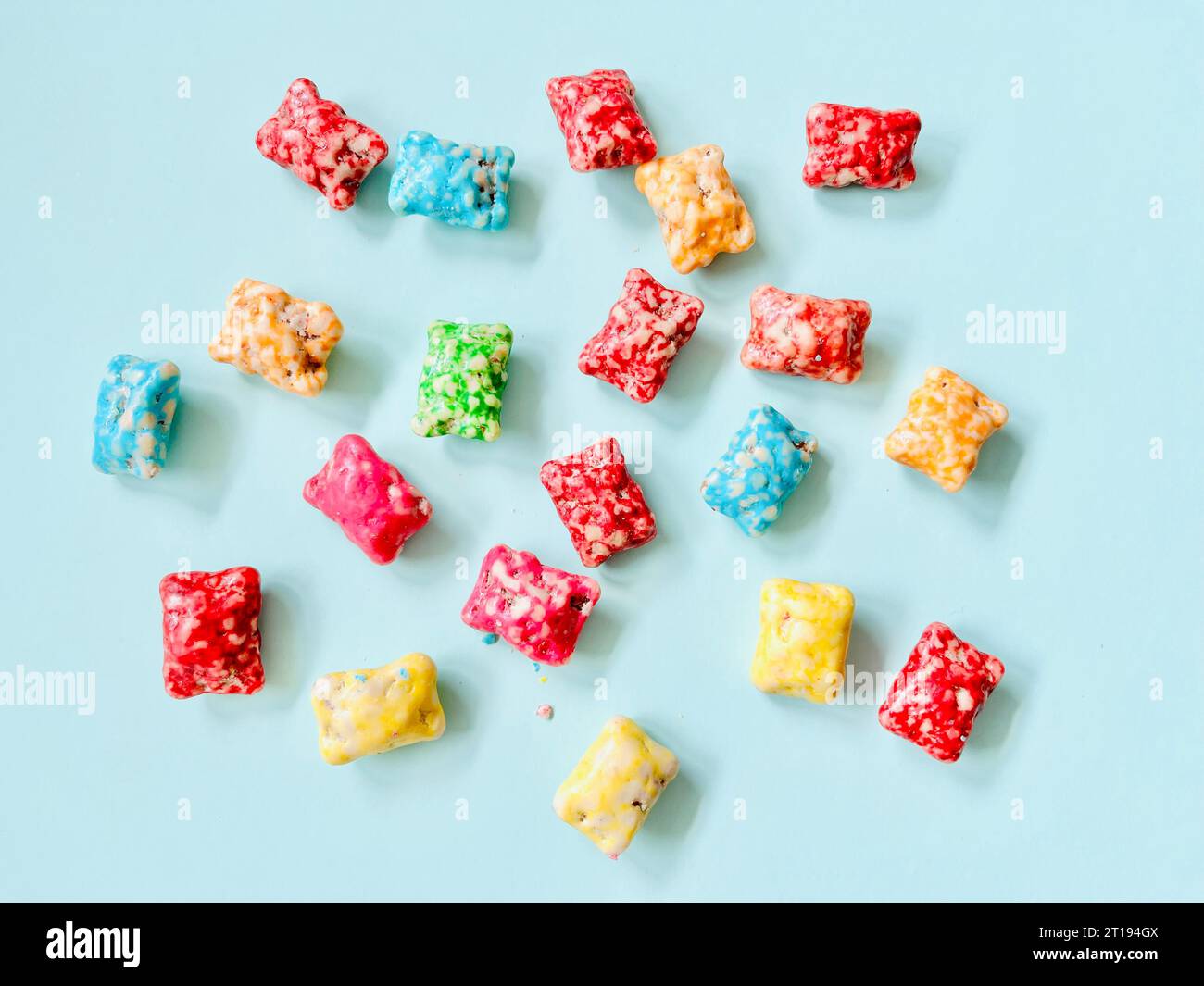 Overhead view of multi coloured sweets on a turquoise background Stock ...