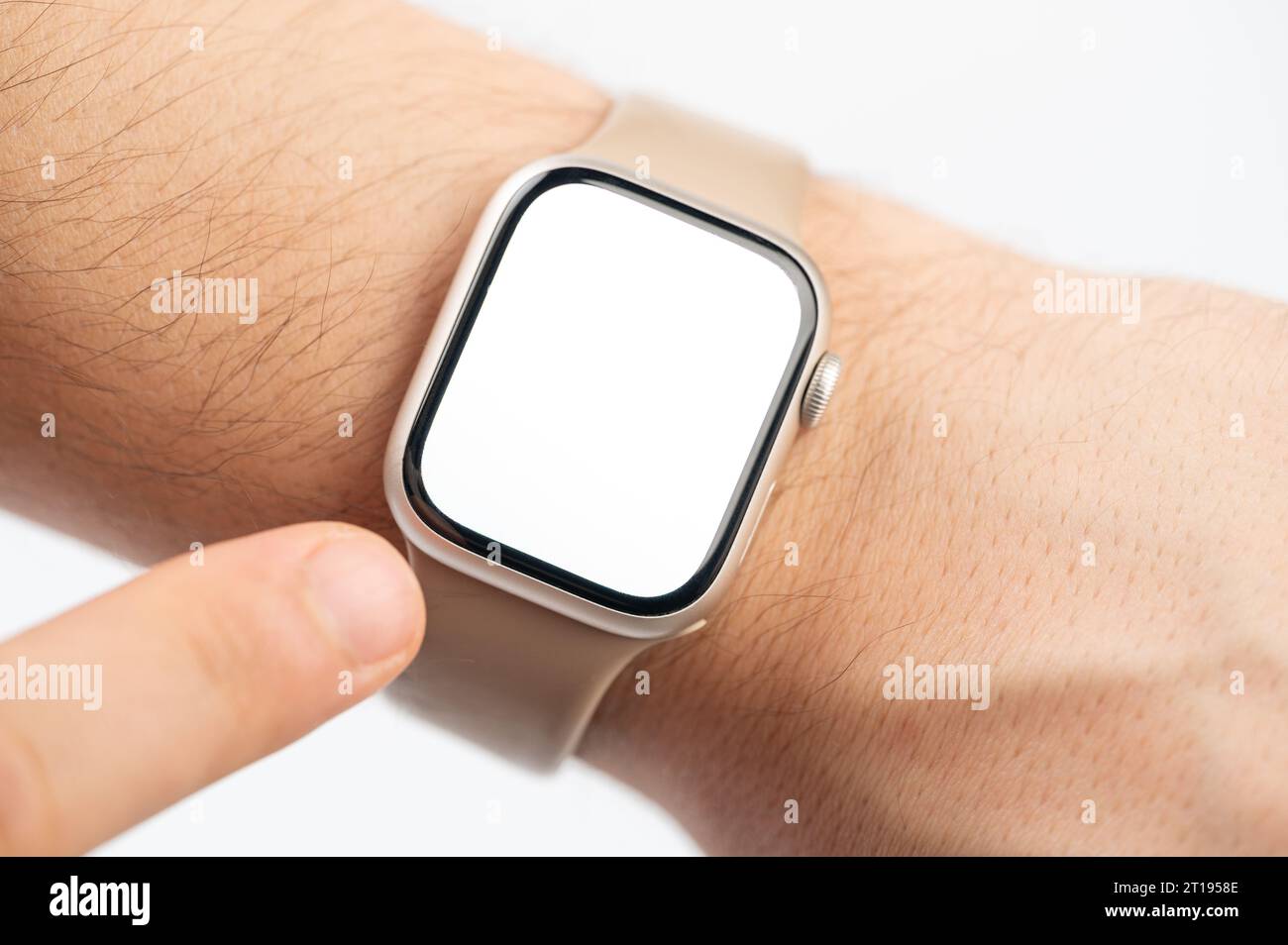 Touch smartwatch screen with finger on wrist isolated studio background ...