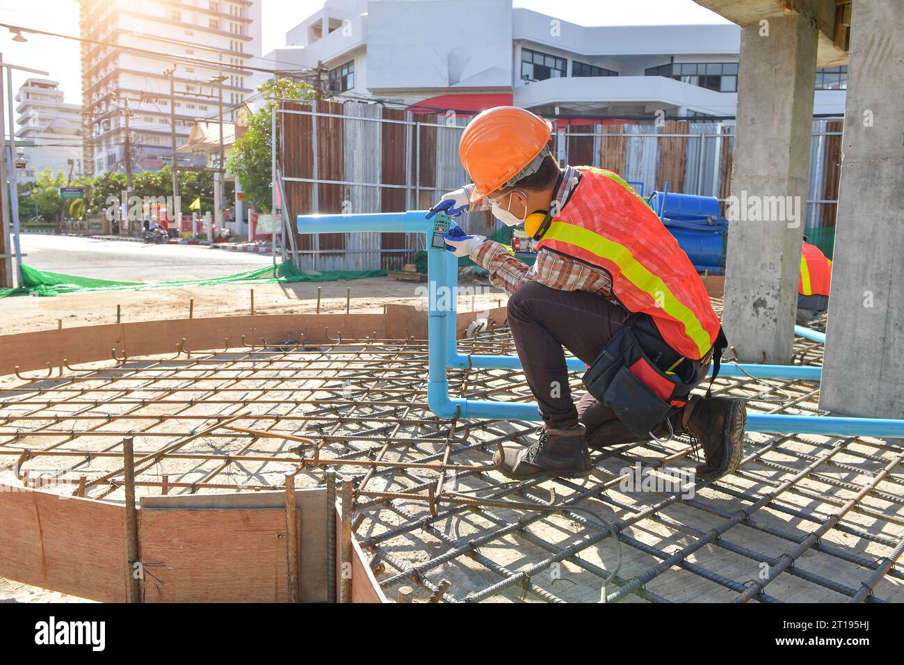 Construction worker using a Laser measuring tool on a construction site ...